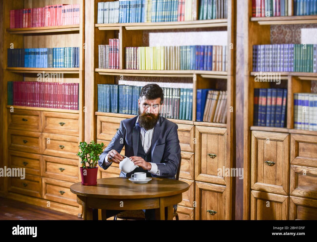 Aristocratic traditions concept. Man in classic suit sits in vintage ...