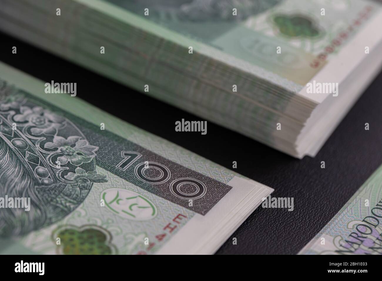 The banknotes lie in piles on a desk top during a cash financial ...