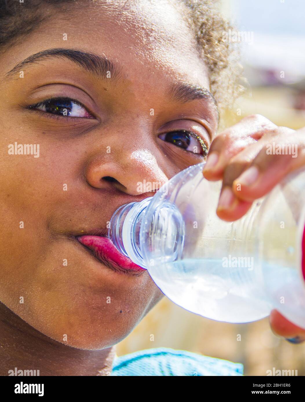 happy young girl quenches her thirst happy with fresta water drunk from ...