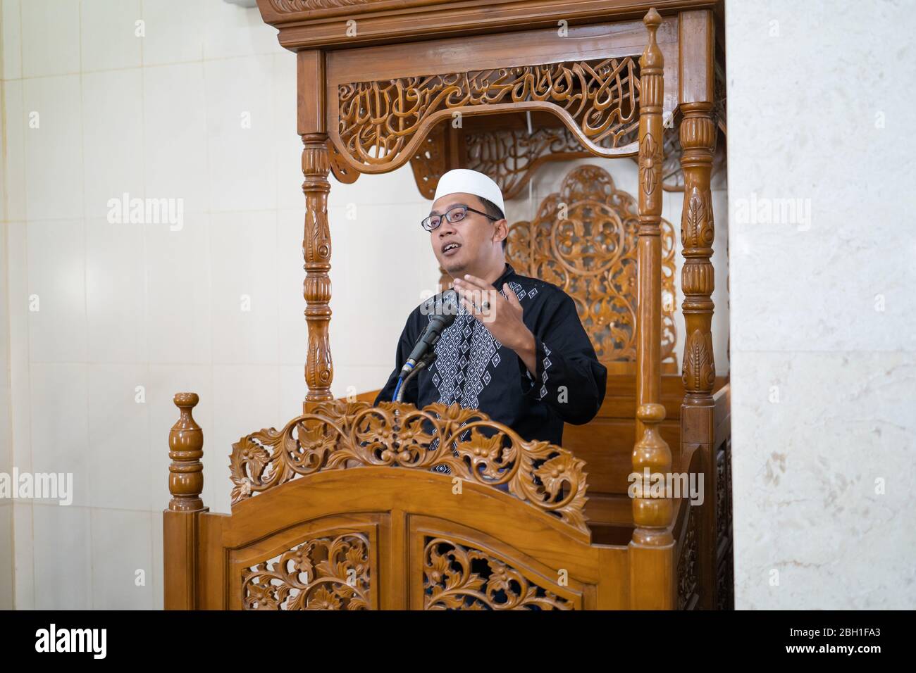 portrait of muslim male preacher sharing about islam during prayer time ...