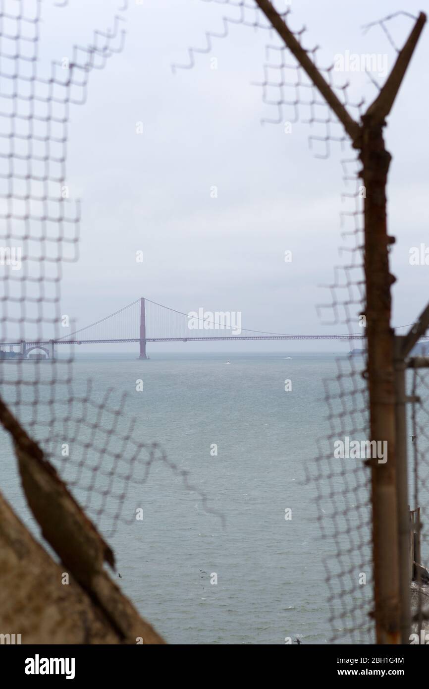 Golden Gate Bridge viewed through broken fencing at Alcatraz Stock ...