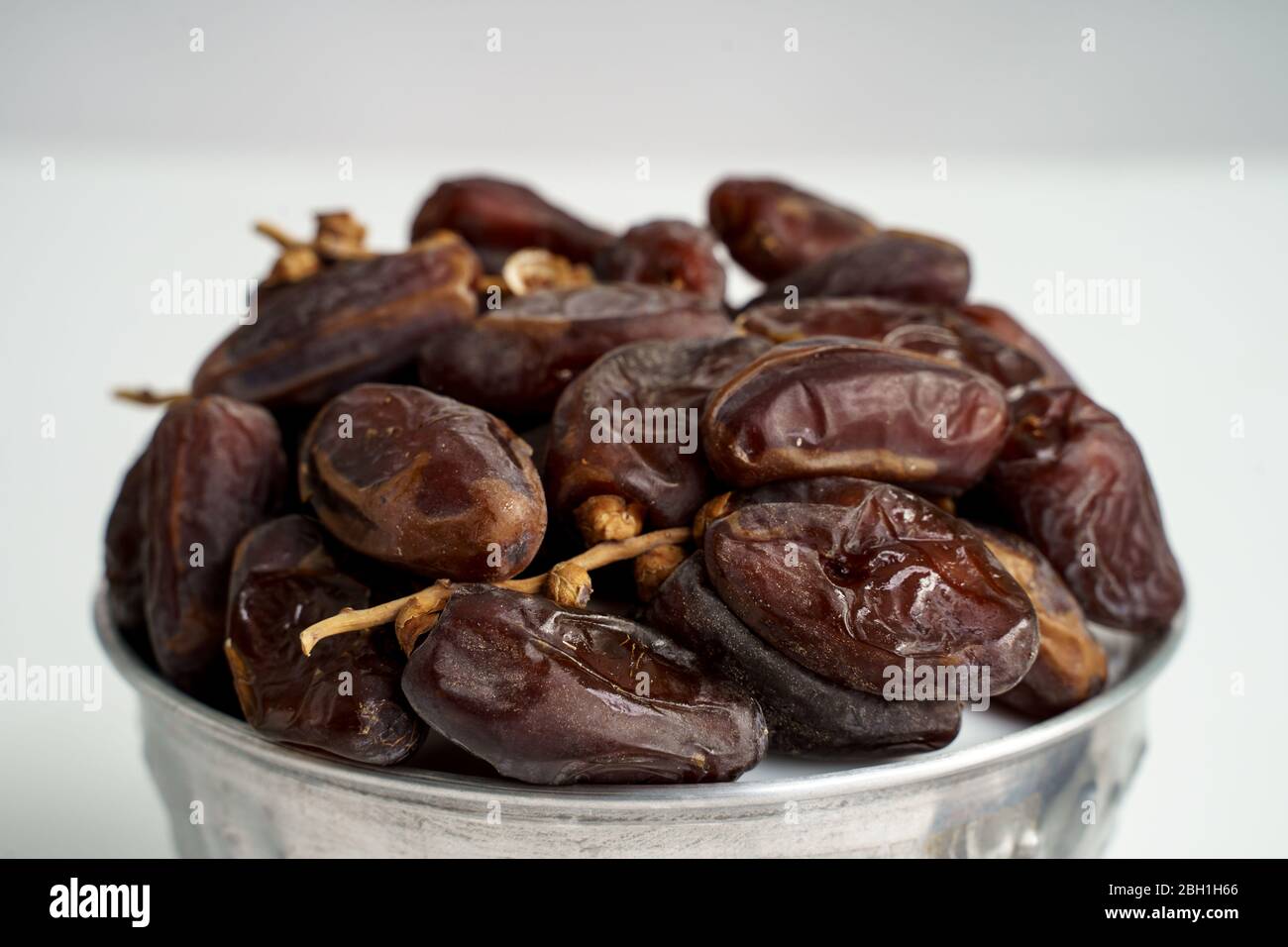 Dates fruit in the bowl on white background. Medjool dried date palm ...