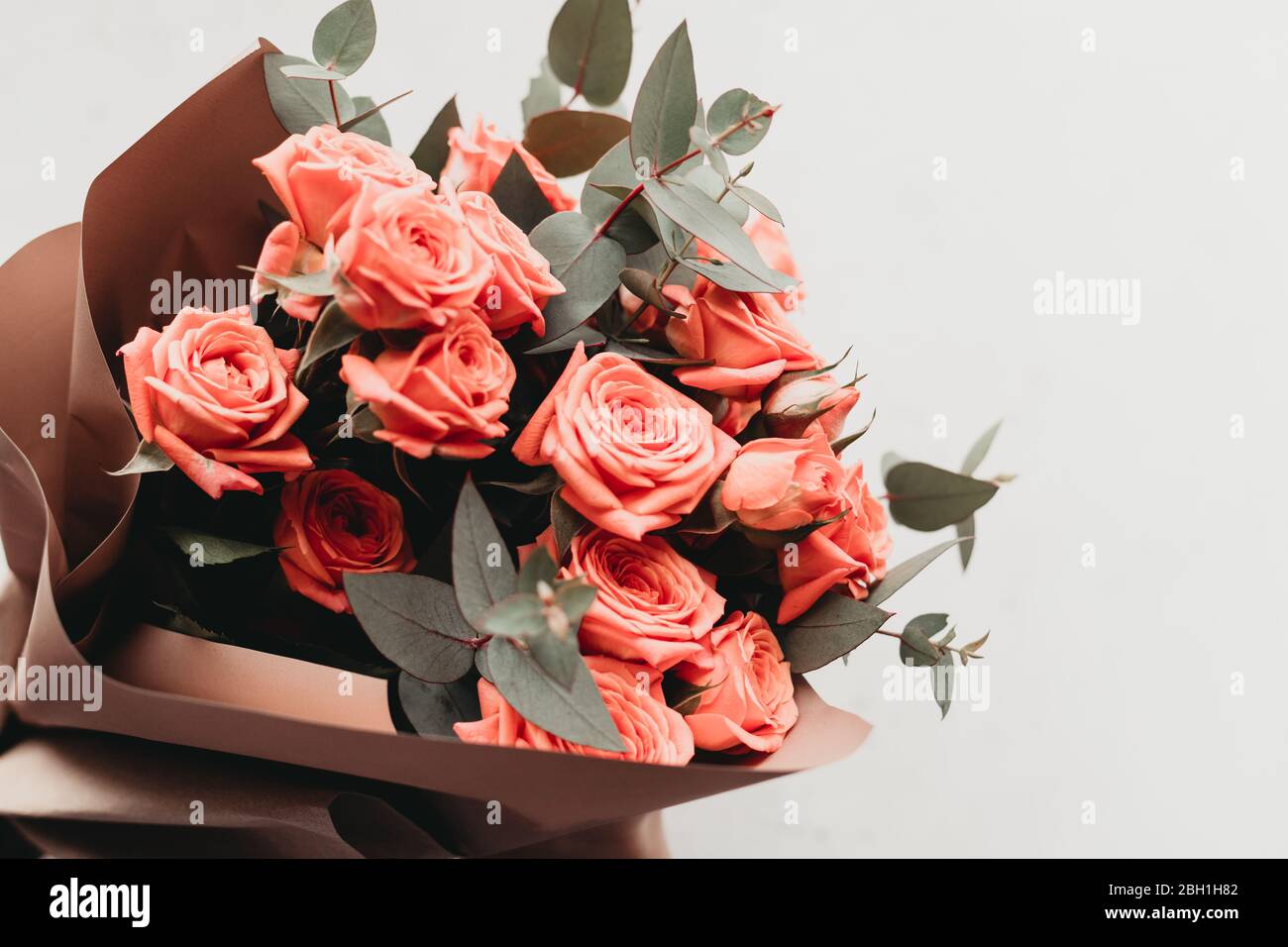 Bouquet is made from coral spray roses and eucalyptus branches Stock ...