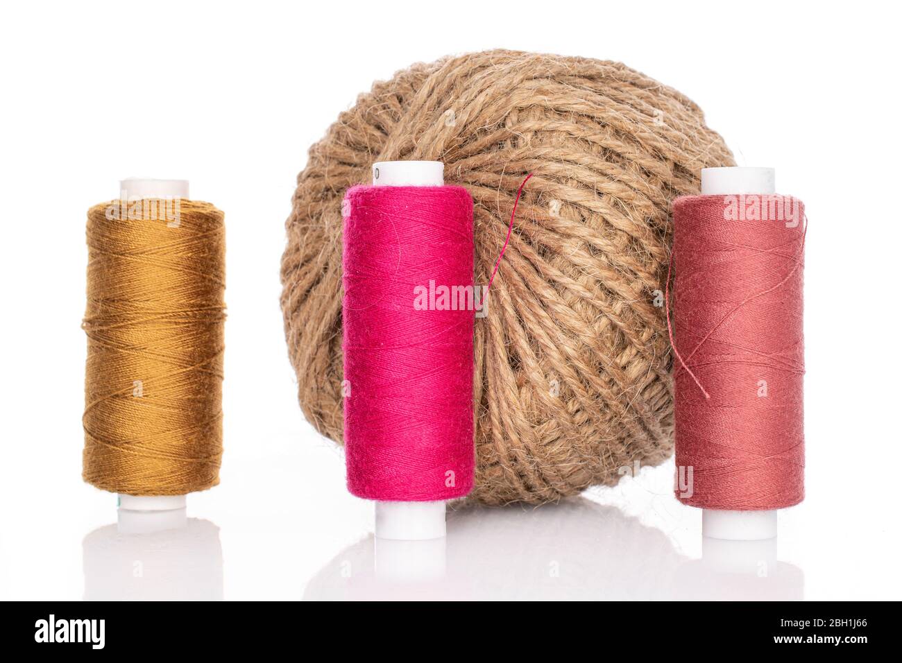 Group of four whole thread spools isolated on white Stock Photo - Alamy