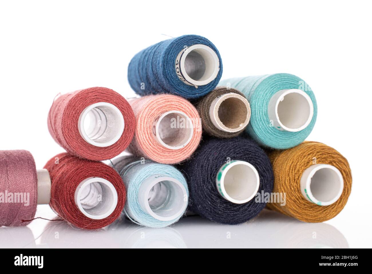 Group of four whole thread spools isolated on white Stock Photo - Alamy