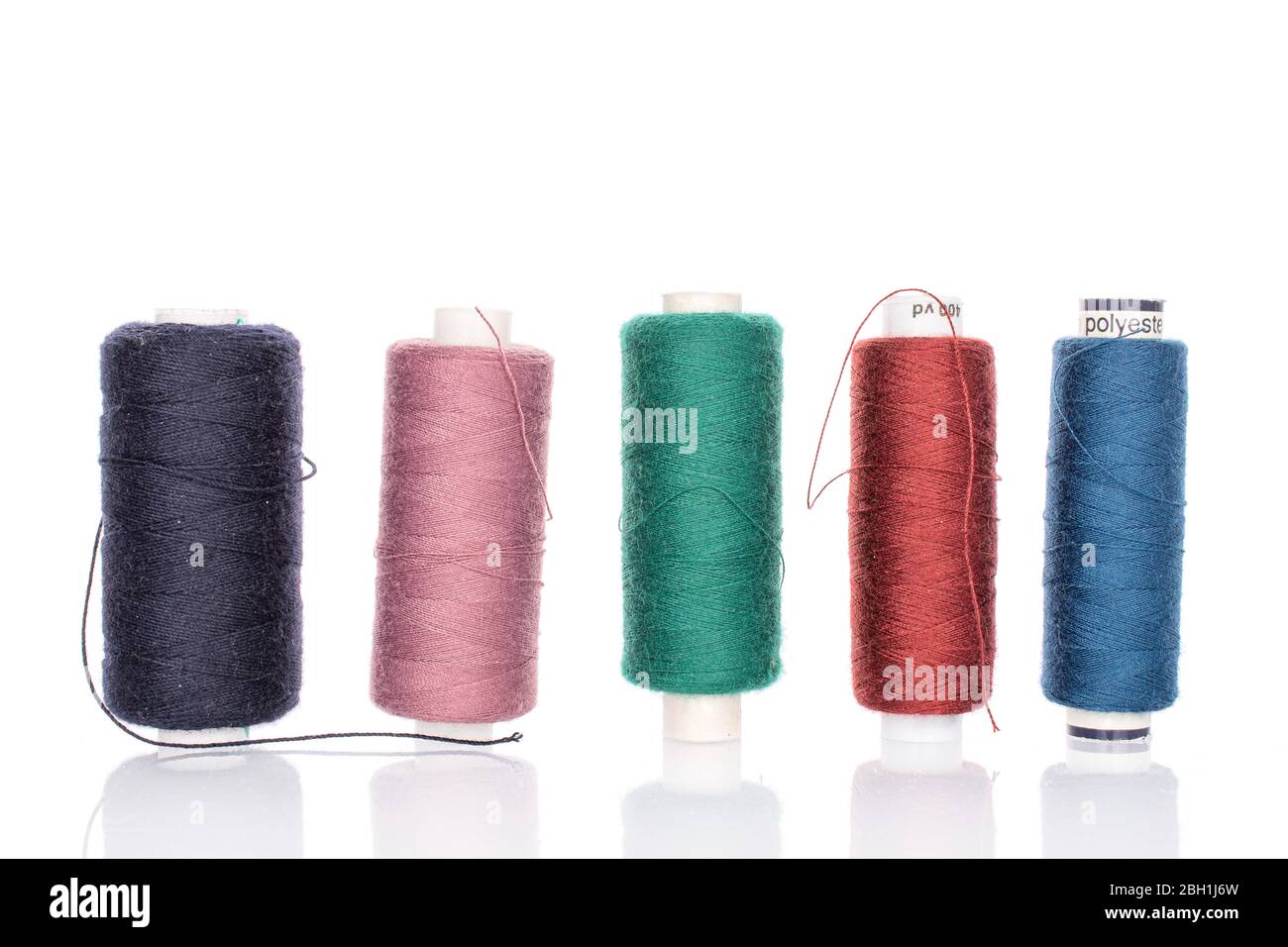 Group of five whole thread spools in row isolated on white Stock Photo ...