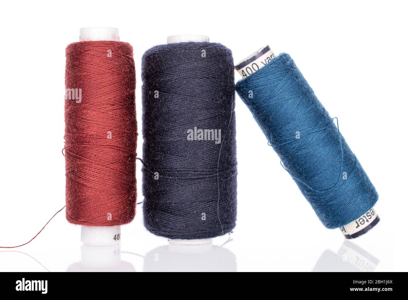 Group of three whole thread spools isolated on white Stock Photo - Alamy