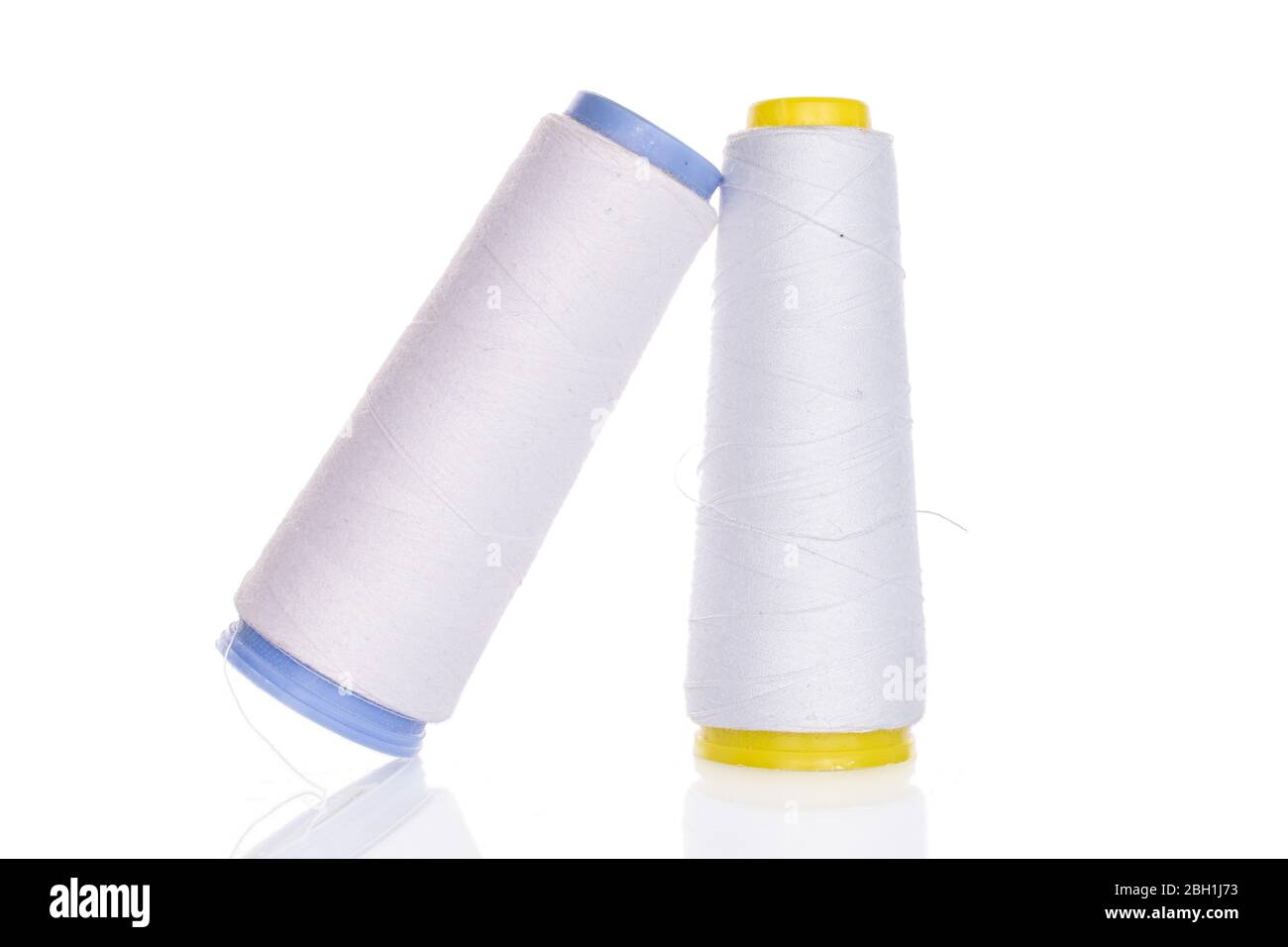Group of two whole white thread spool isolated on white Stock Photo - Alamy