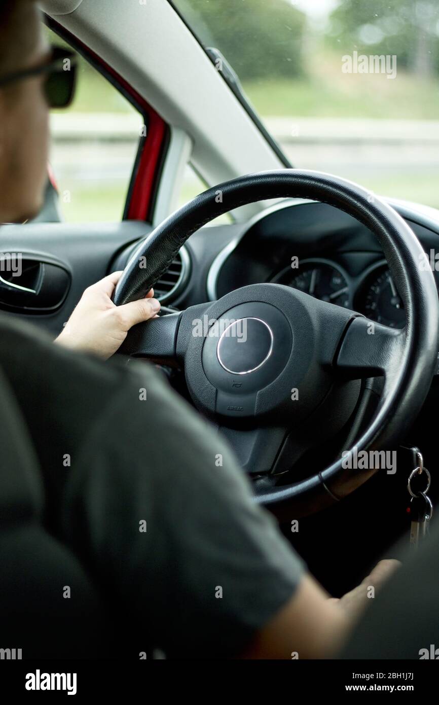 Man driving his car. hand on steering wheel Stock Photo - Alamy