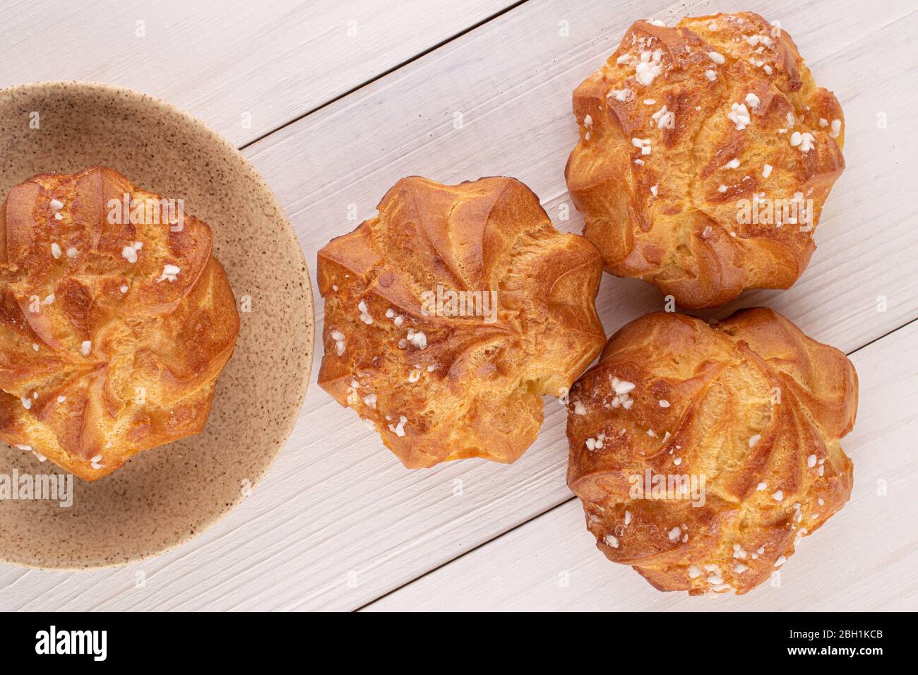 Group of four whole fresh baked profiterole on white wood Stock Photo ...