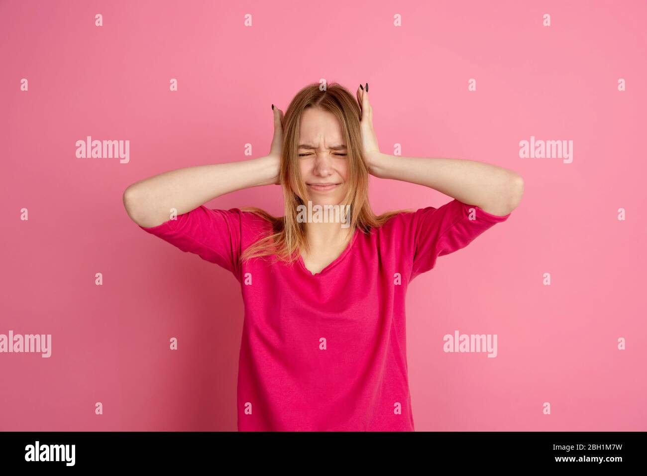 Crazy shocked, upset. Caucasian young woman's portrait isolated on pink ...