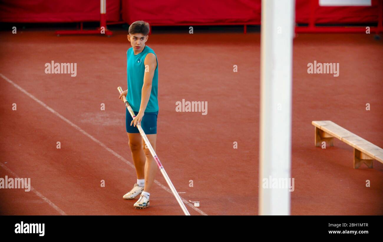 Pole vault training on the stadium - a young man preparing before the ...