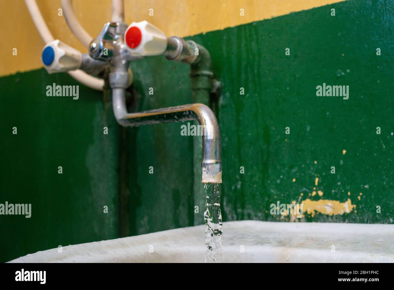 close-up view of old stained water tap with selective focus and ...