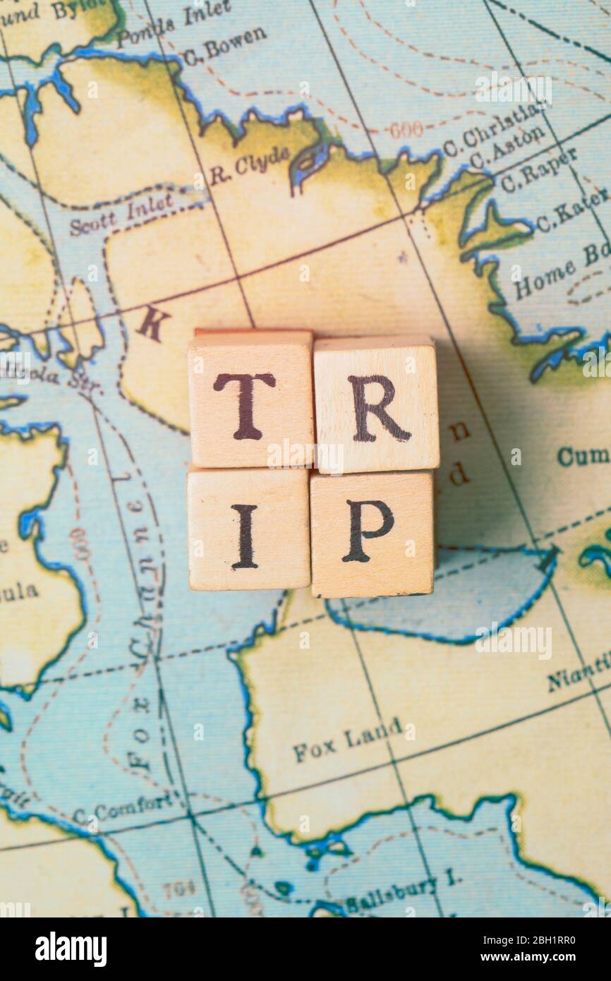 Trip word written in wooden blocks on a vintage travel map Stock Photo ...