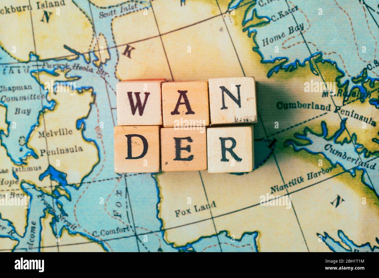 Wander word written in wooden blocks on a vintage travel map Stock ...