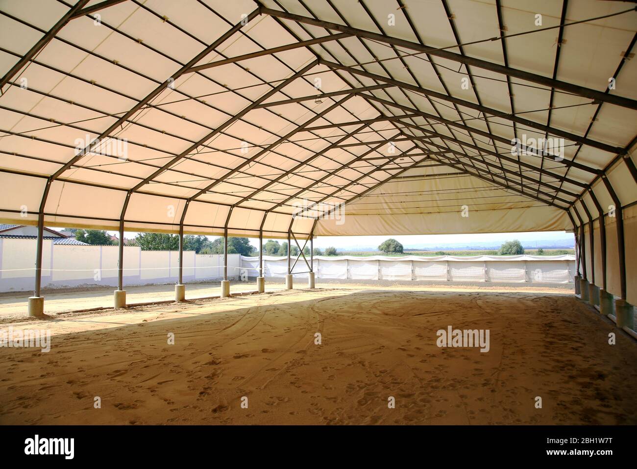 View in an empty indoor riding hall for horses and riders. The riding ...