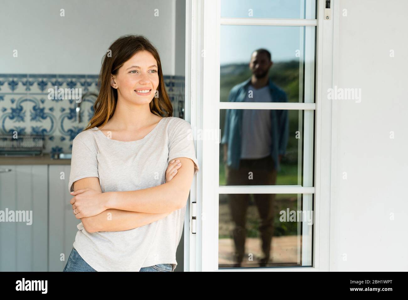 Woman standing outside door hi-res stock photography and images - Alamy