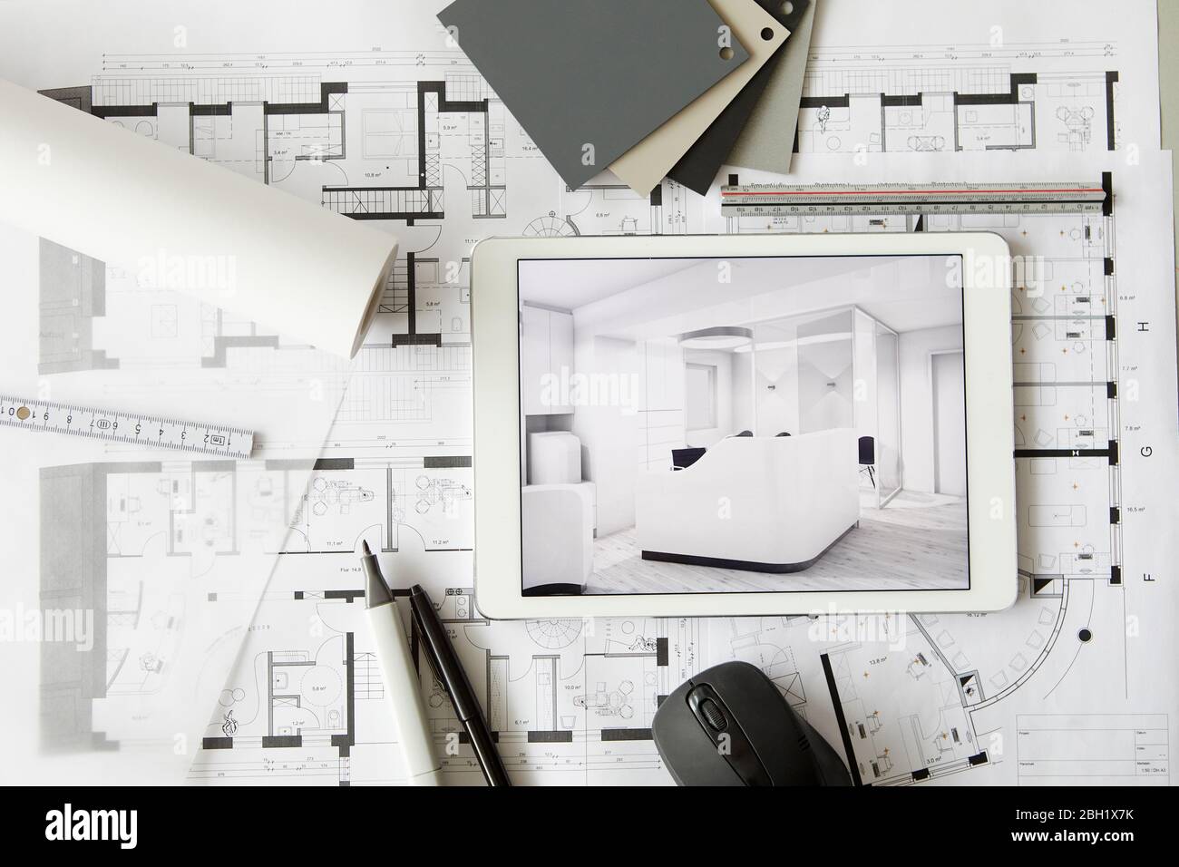 Architectural blueprints and digital tablet displaying modern showcase ...