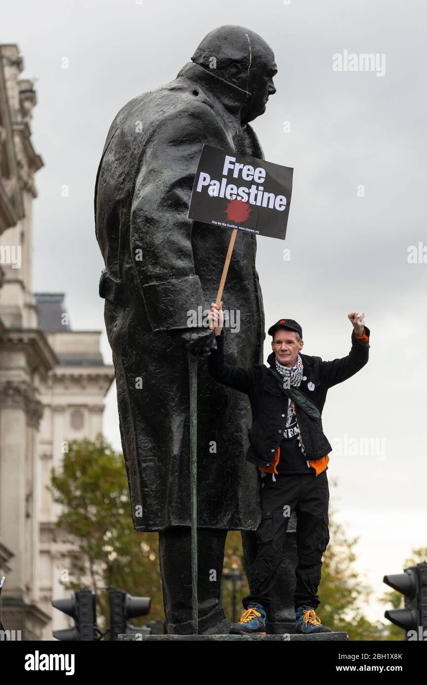 Protester under a statue of Winston Churchill in Parliament Square ...