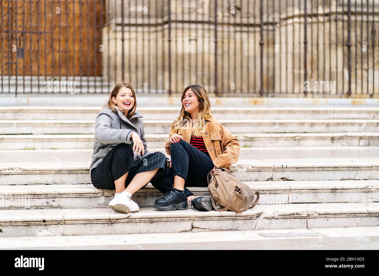 Two women sitting on stairs hi-res stock photography and images - Alamy