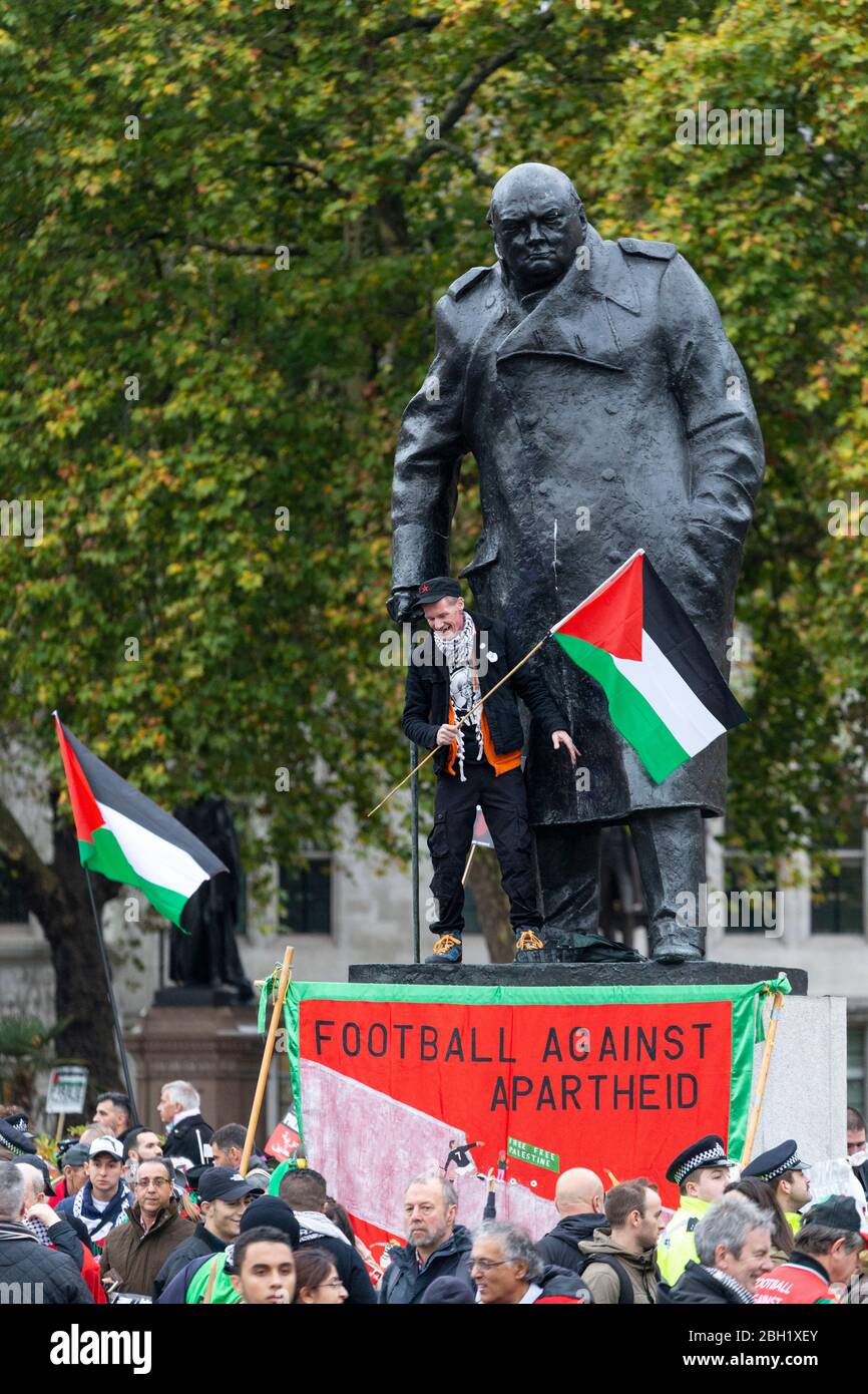 Protester under a statue of Winston Churchill in Parliament Square ...