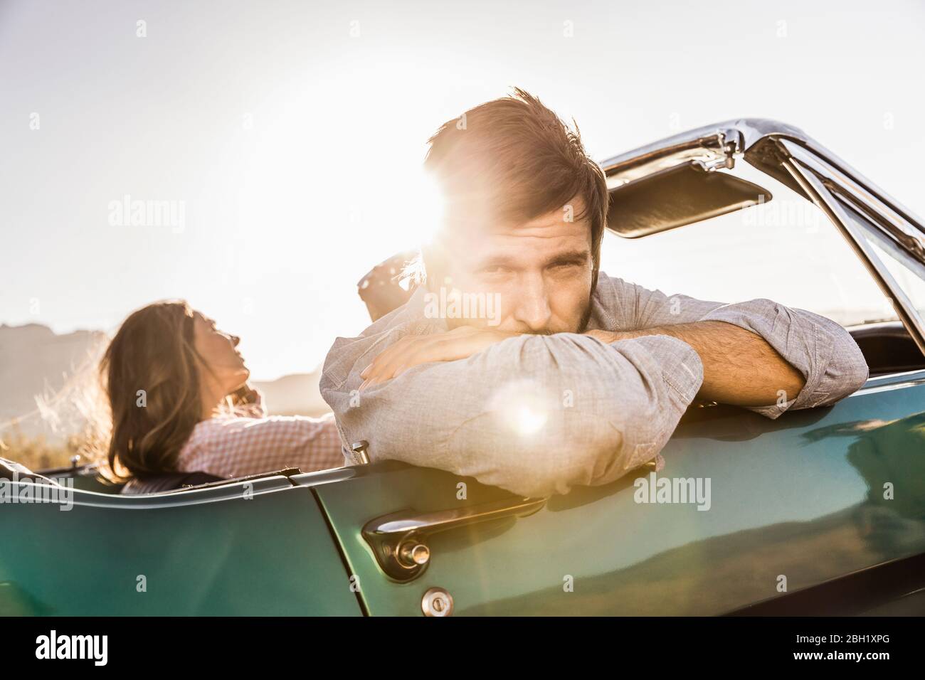 Couple in convertible car on a road trip Stock Photo - Alamy
