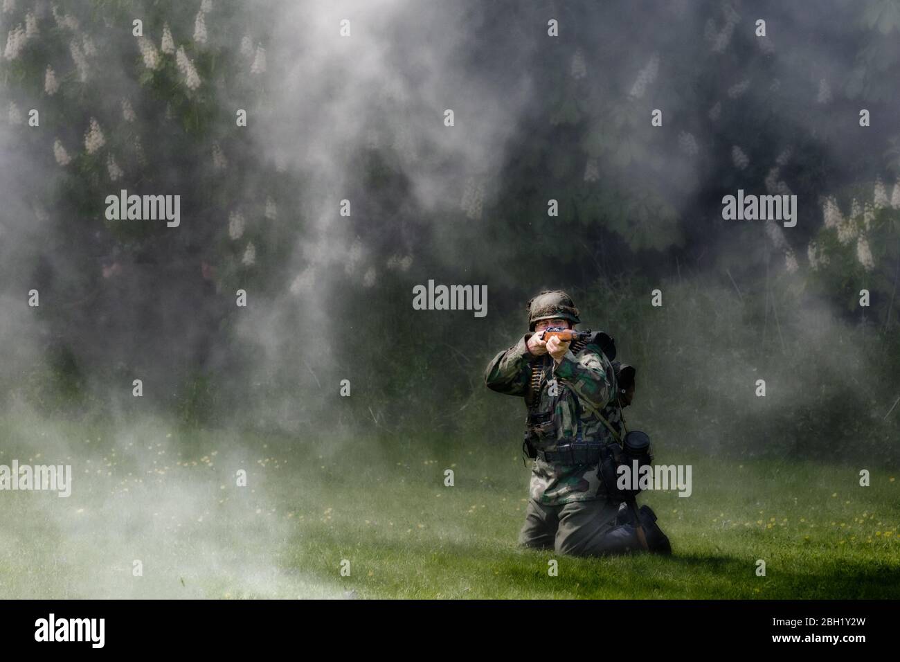 WW2 soldiers on the battlefield reenacting battle scenes with guns and ...