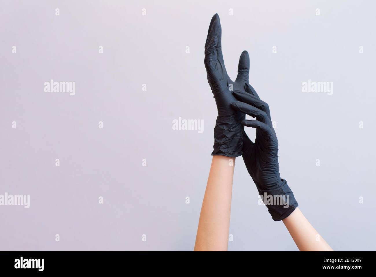 protection of gloved hands from coronavirus, female hands in black ...