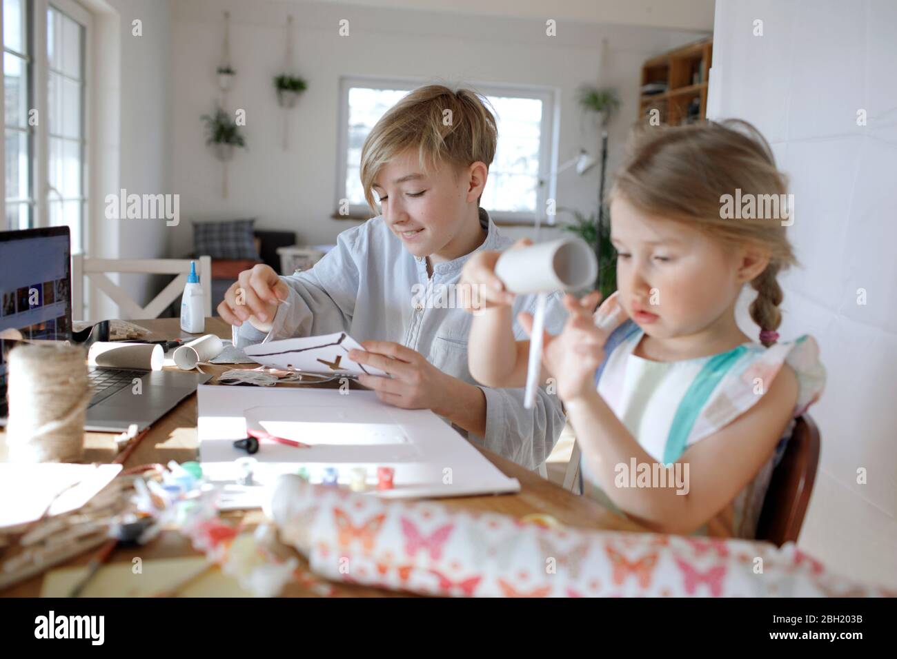 Boy and his little sister tinkering at home Stock Photo - Alamy