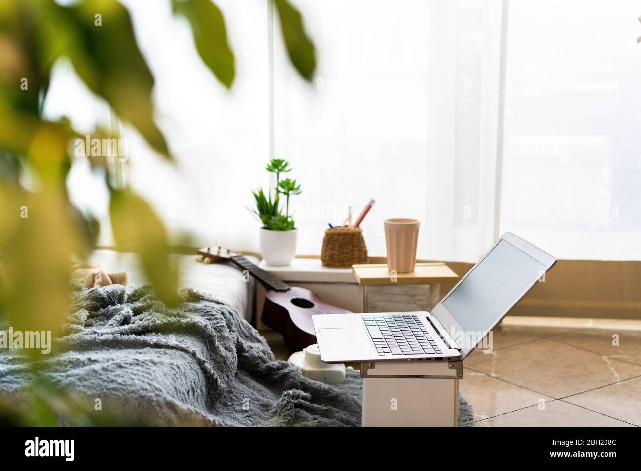 Laptop on a box at the bedside Stock Photo - Alamy