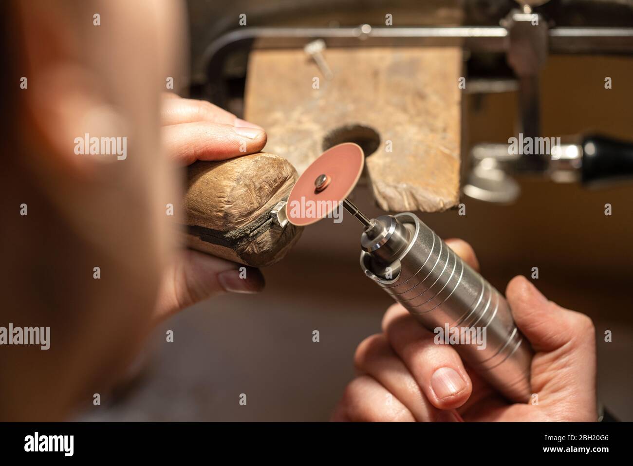 Hand of female goldsmith working with grinder on silver ring Stock ...