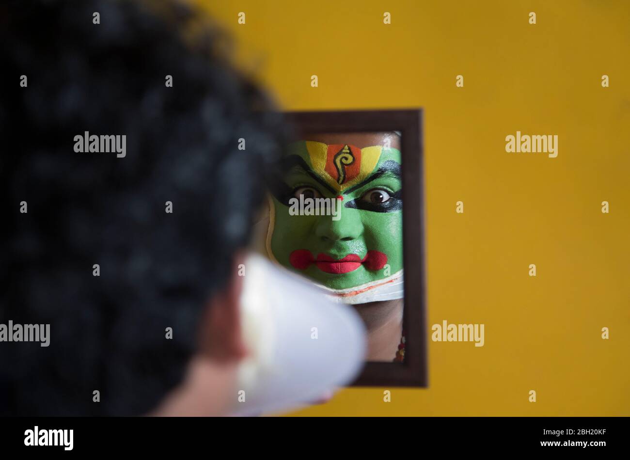 Kathakali dancer looking in the mirror and smiling Stock Photo - Alamy