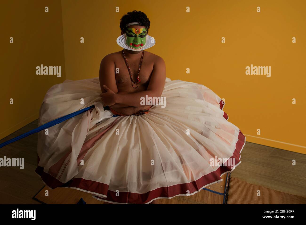Kathakali dancer smiling while wearing his costume before performance ...