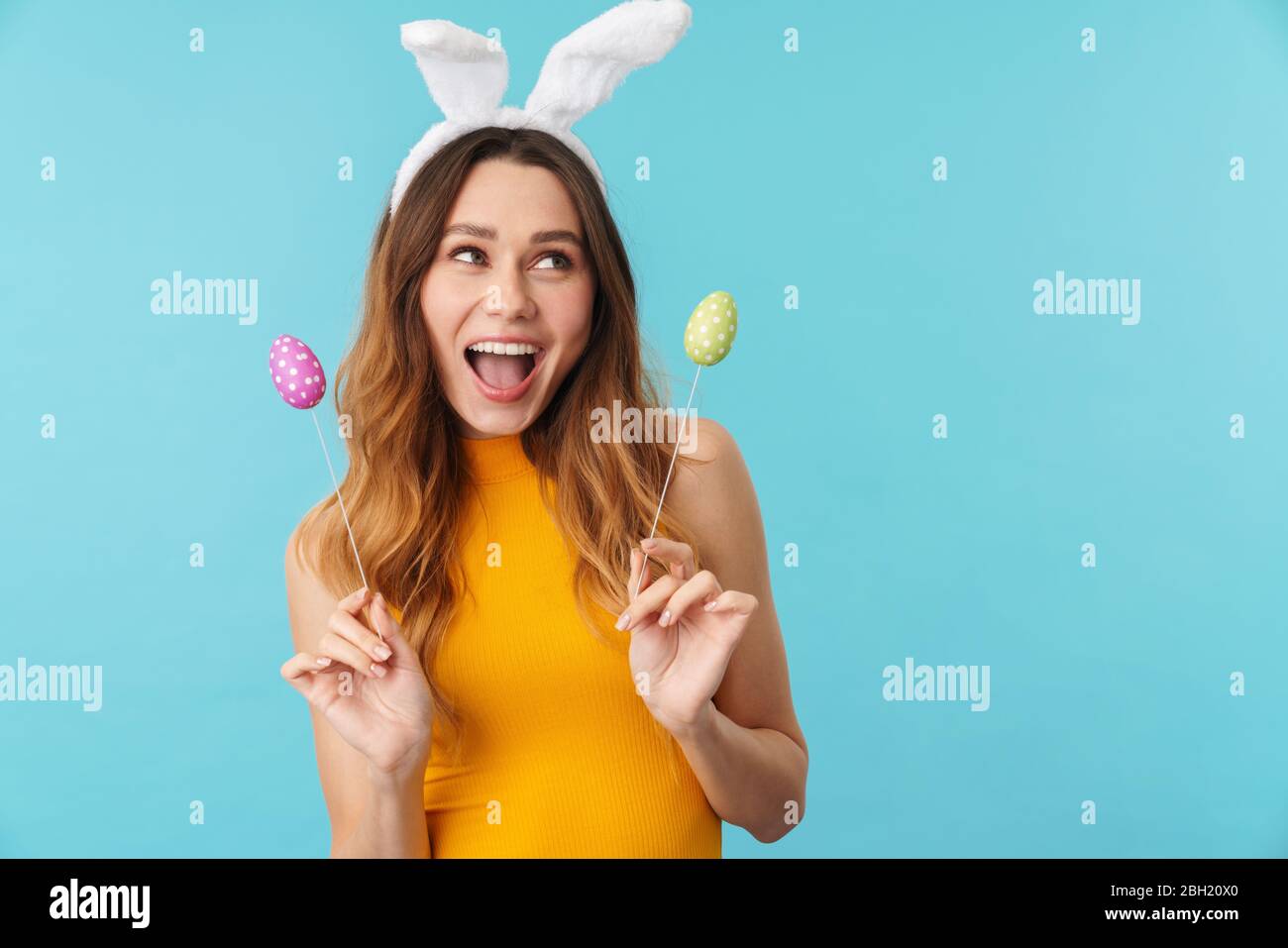 Portrait of a cheerful excited pretty young girl standing isolated over ...
