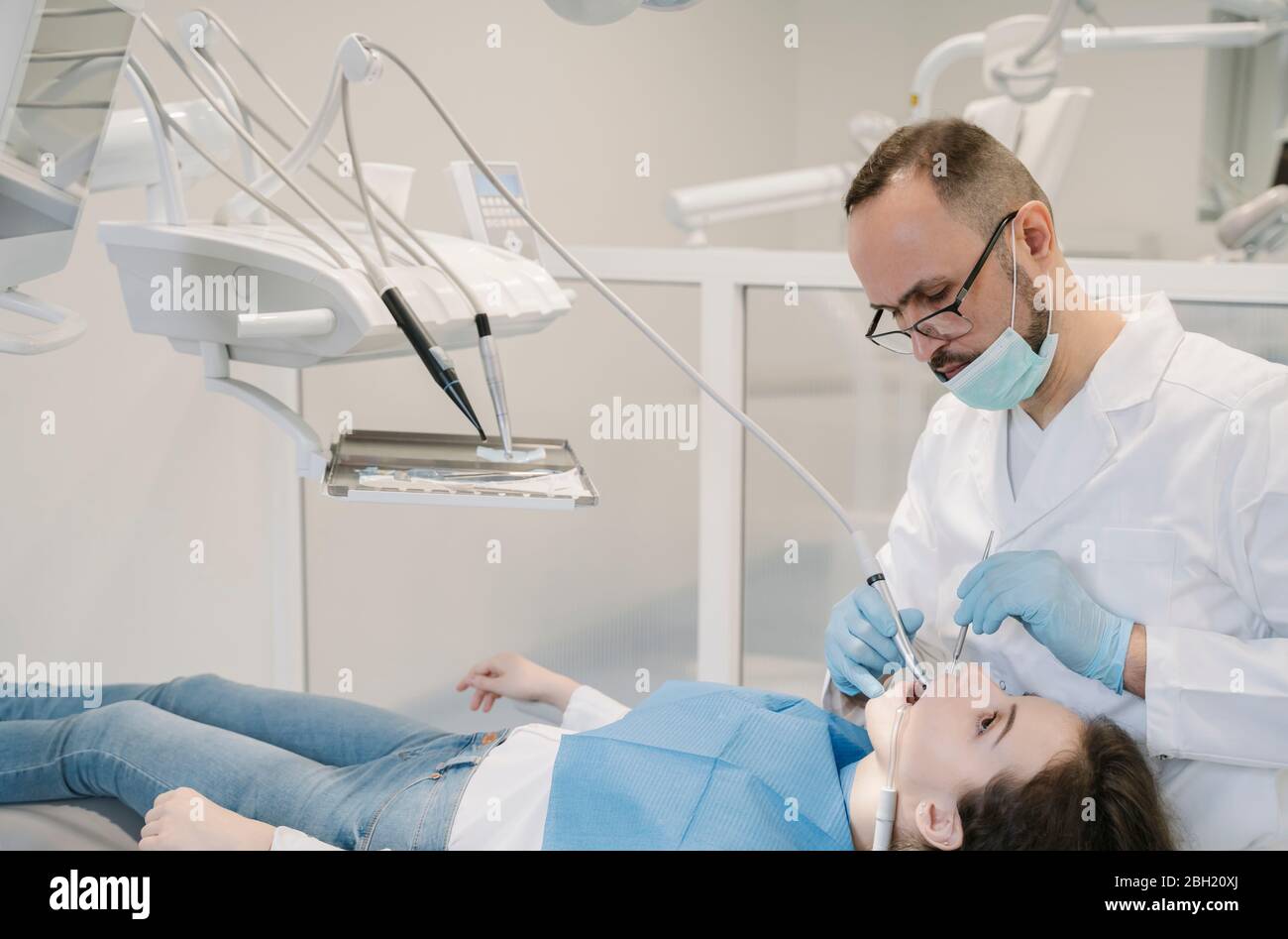 Young woman getting dental treatment in clinic Stock Photo - Alamy
