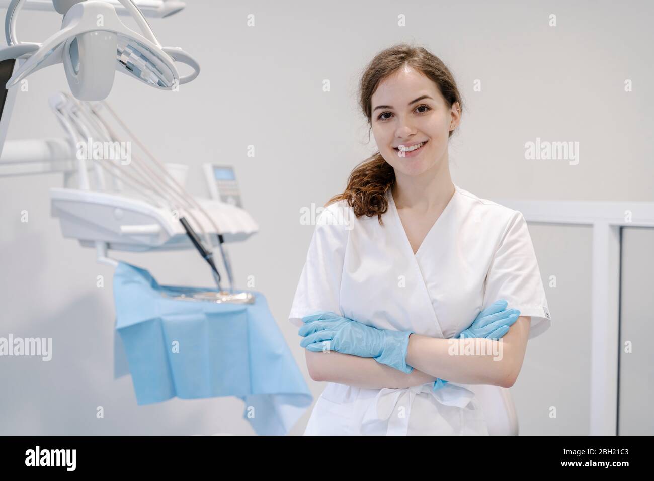 Dentist standing arms crossed in hi-res stock photography and images ...