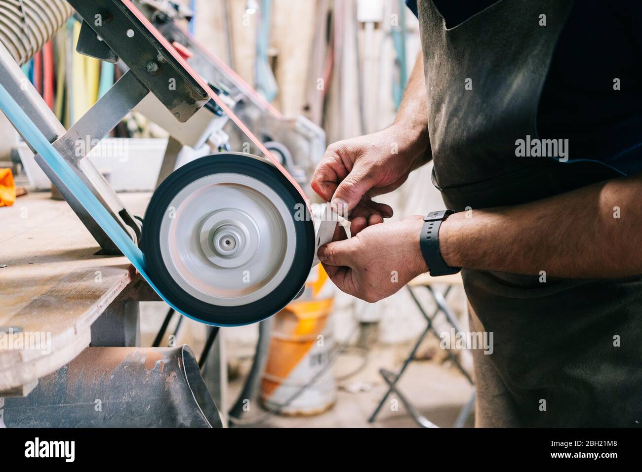 Craftsman making knives in his workshop sharpening the blade Stock ...