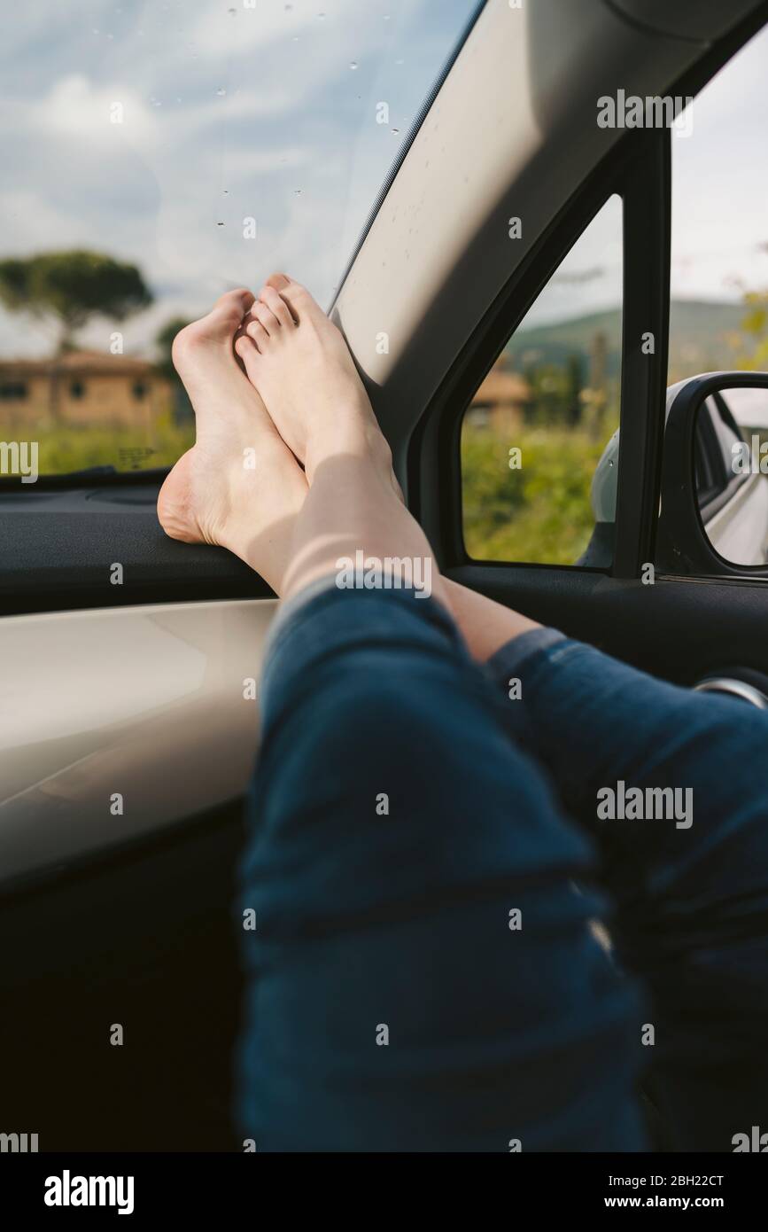Woman's bare feet in a car Stock Photo - Alamy