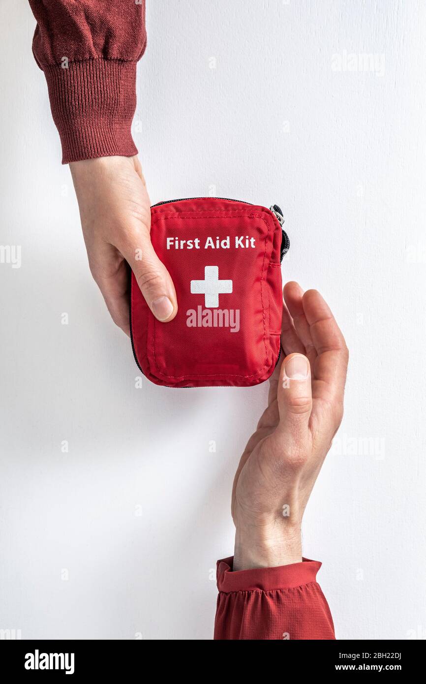 Overhead view of woman handing over first aid kit to man Stock Photo ...