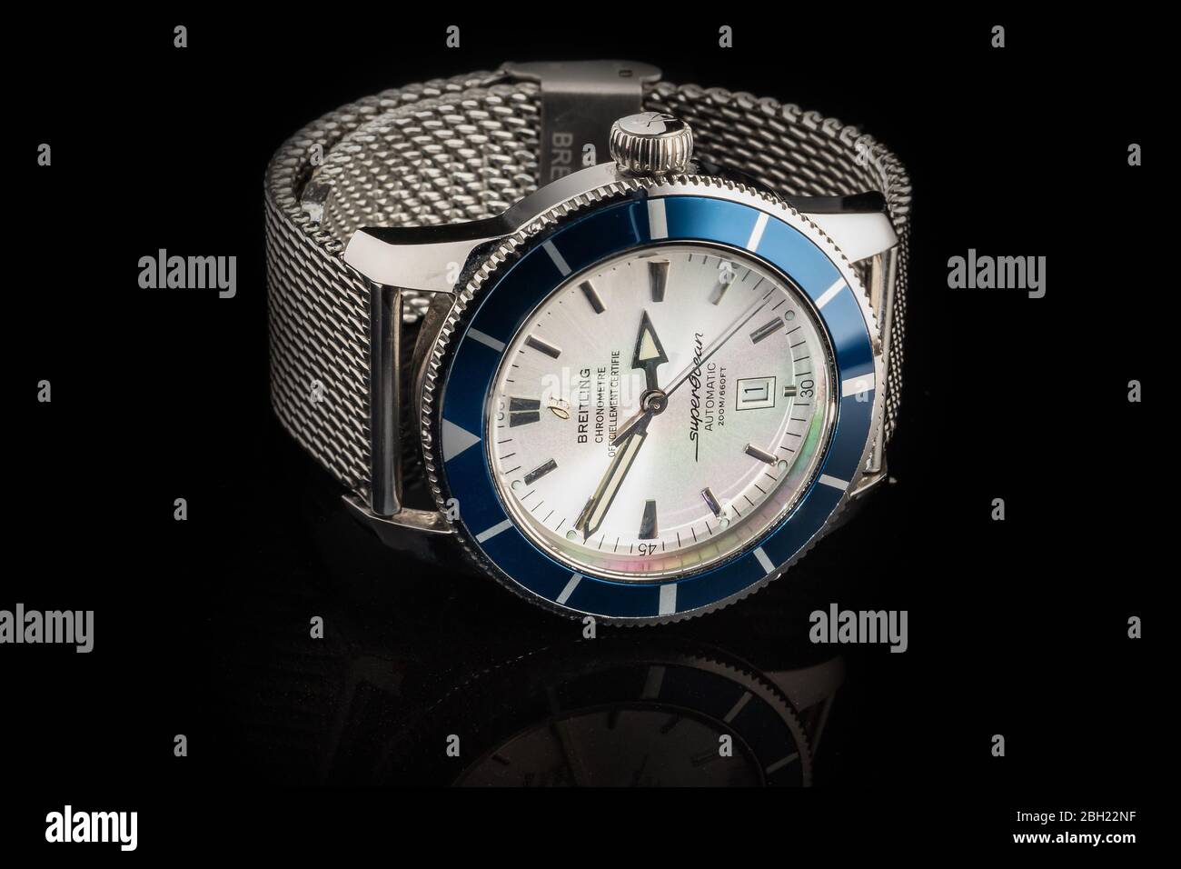 Luxury watches laying flat on a black reflective panel Stock Photo - Alamy