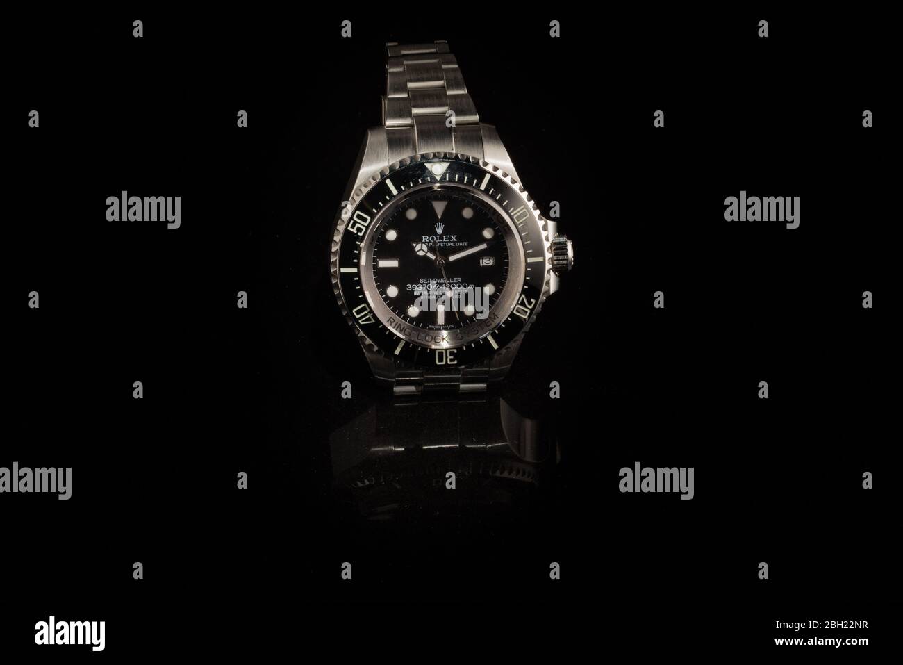 Luxury watches laying flat on a black reflective panel Stock Photo - Alamy