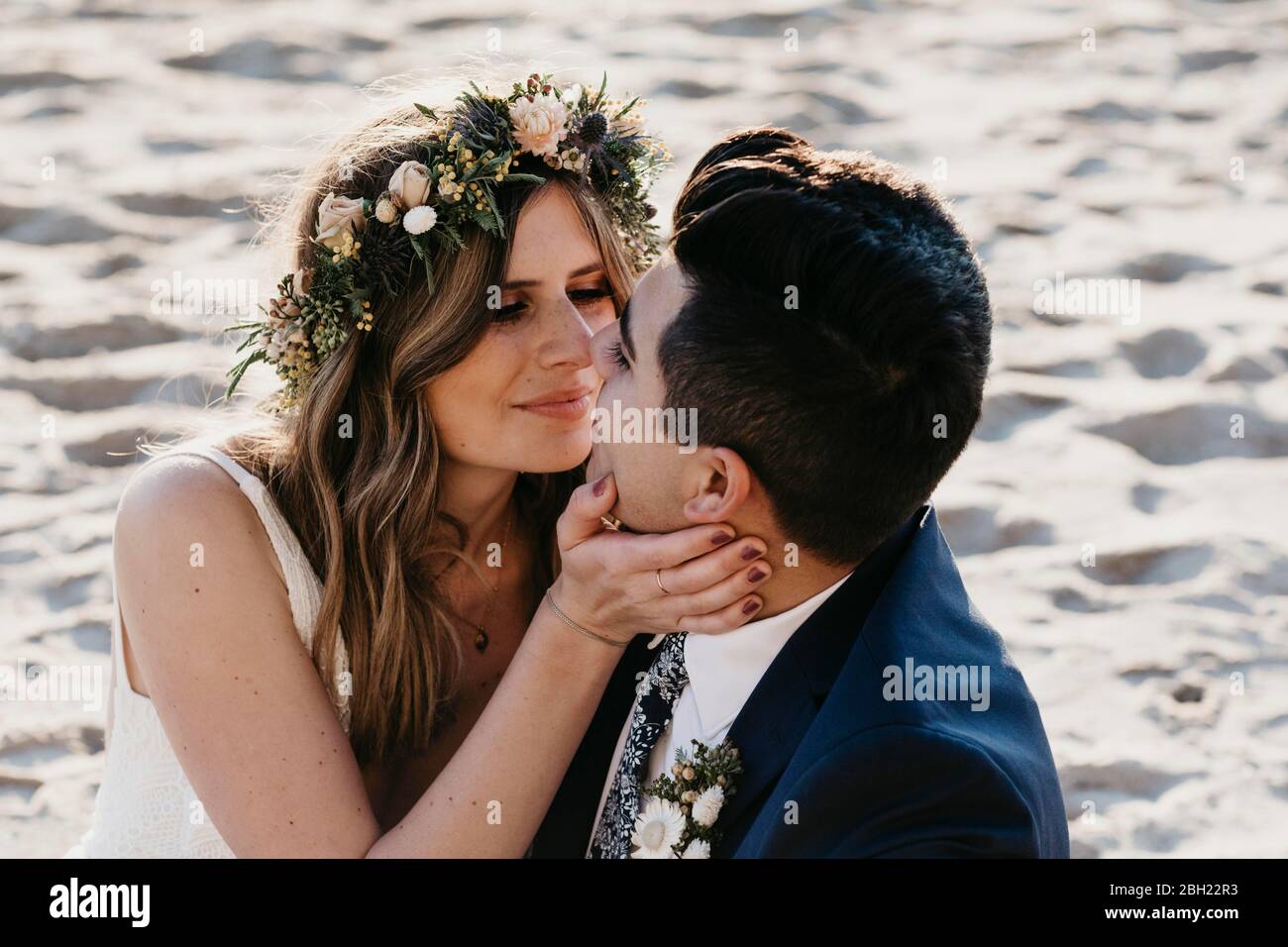 Happy bridal couple kissing each other Stock Photo - Alamy