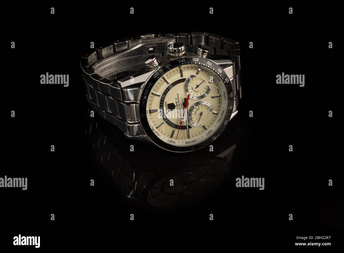 Luxury watches laying flat on a black reflective panel Stock Photo - Alamy