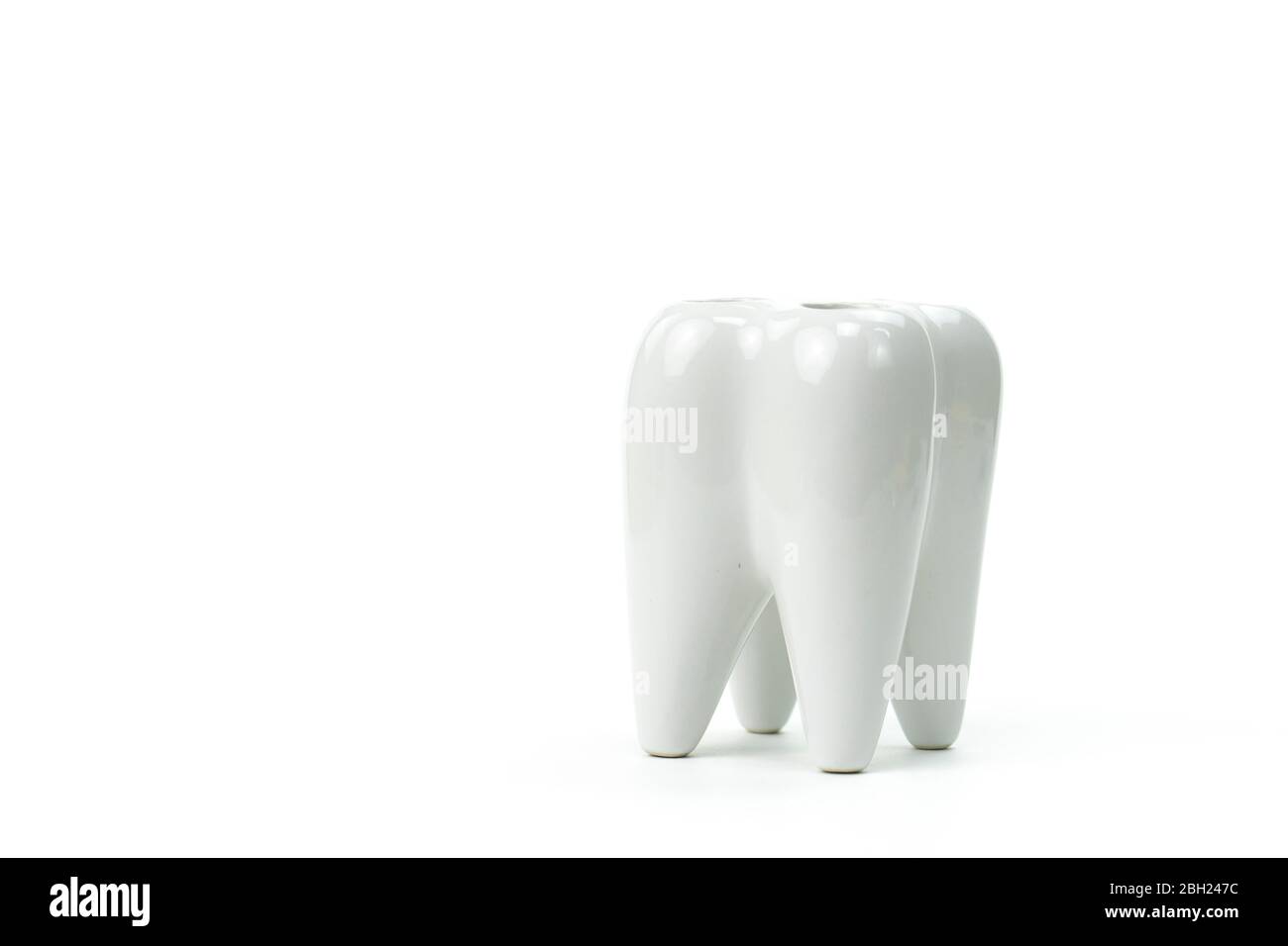 toothbrush stand shaped like primary tooth close up isolated white ...