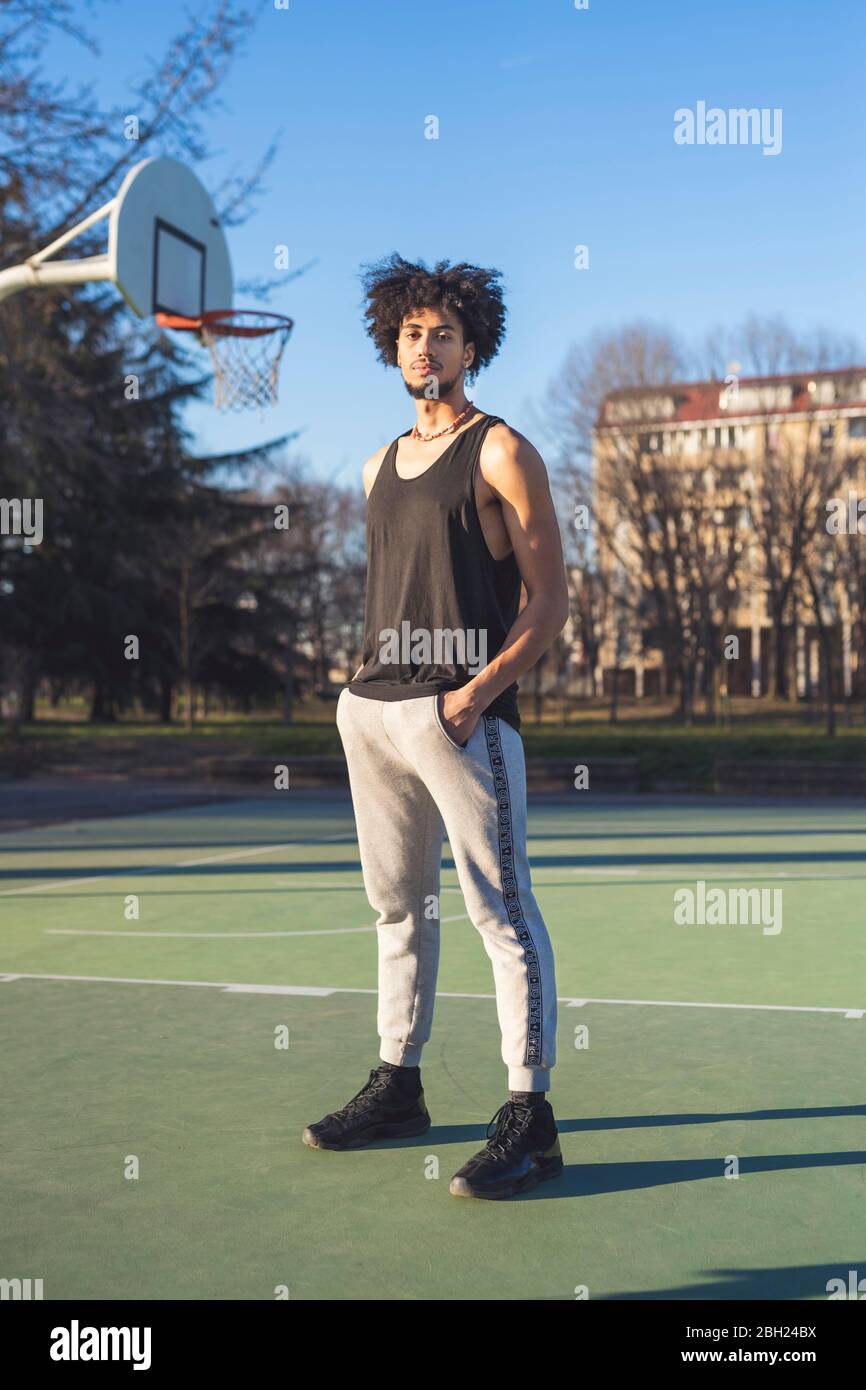 Portrait of young man standing on basketball court Stock Photo - Alamy