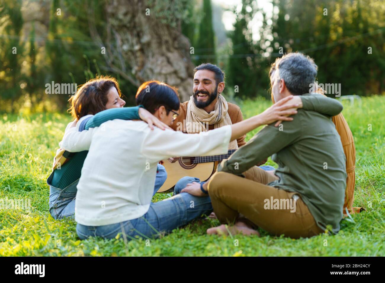 Hugging on grass hi-res stock photography and images - Alamy