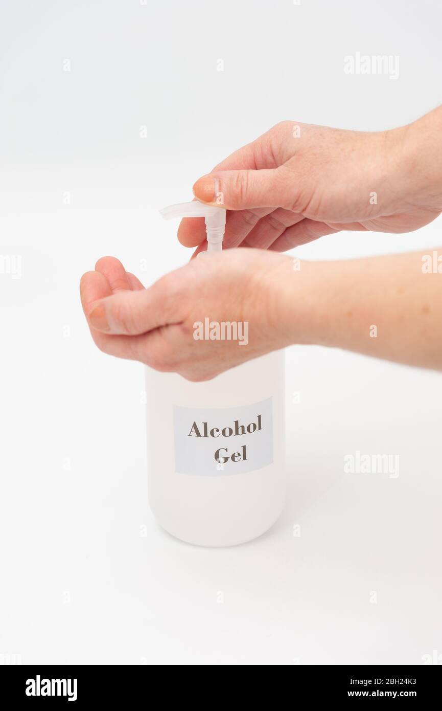 Hands using alcohol gel to protect against coronavirus (COVID-19) and ...