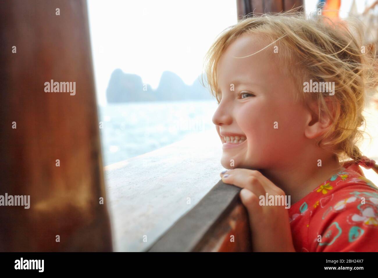 Portrait of smiling little girl on boat trip, Krabi, Thailand Stock ...