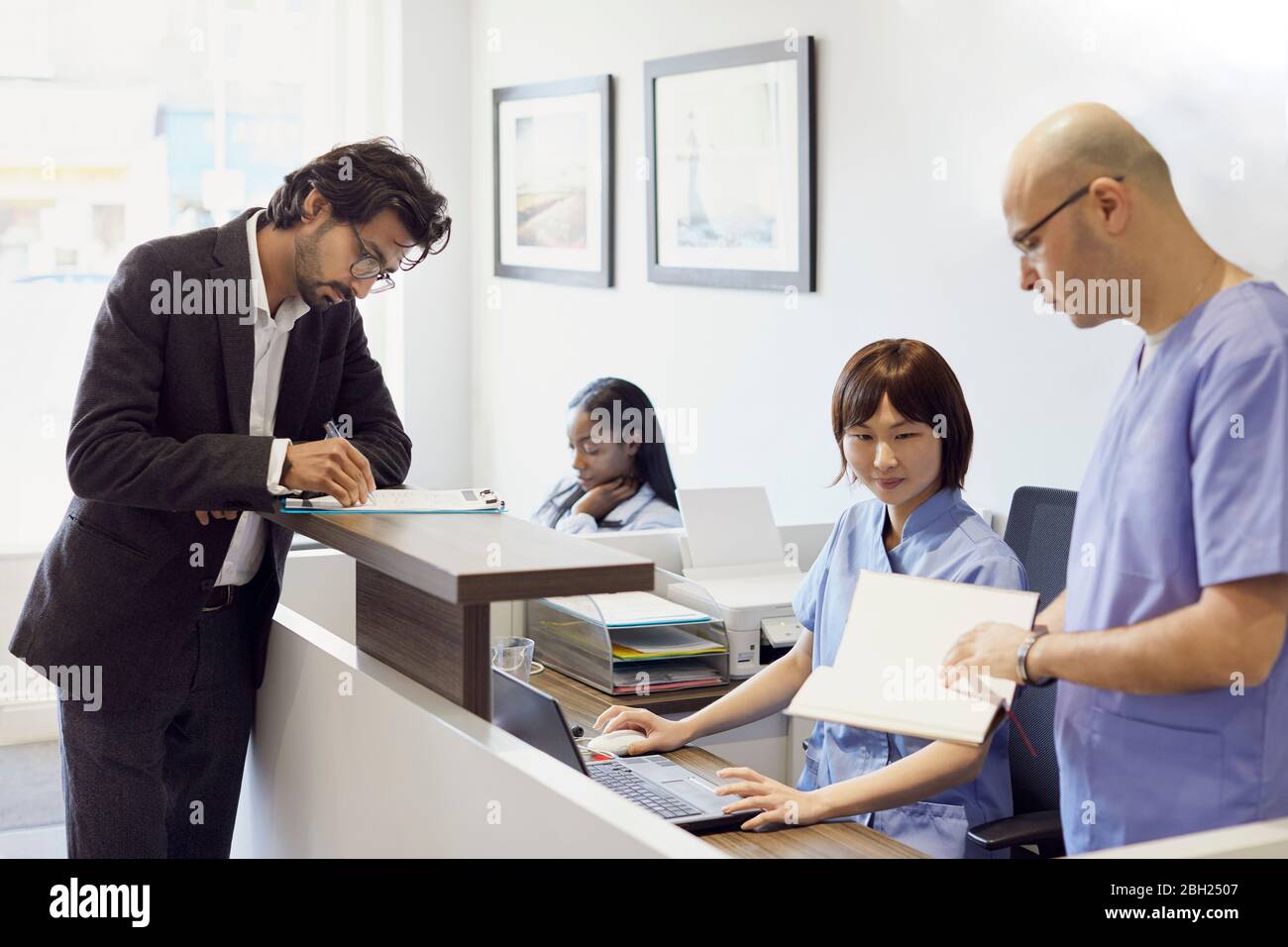 Reception desk of a dental practice Stock Photo - Alamy