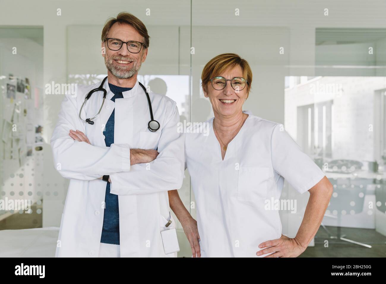 Portrait of confident doctor and assistant in medical practice Stock ...